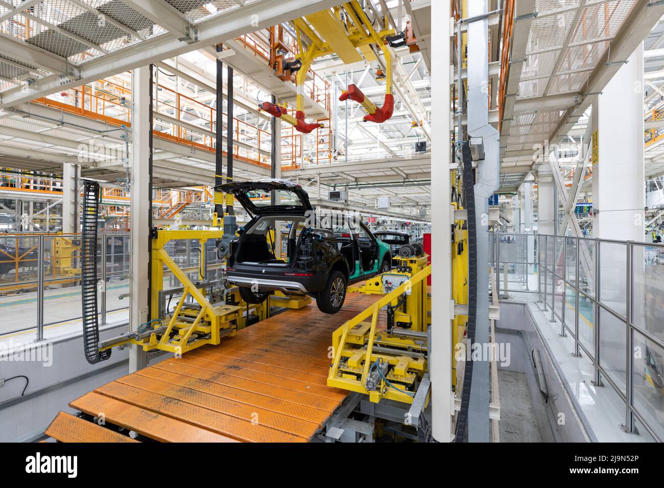 Car bodies are on assembly line. Factory for production of cars. Modern ...