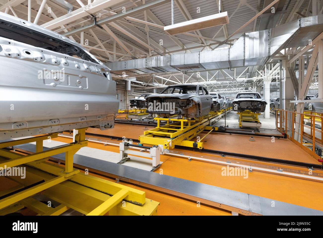 Car bodies are on assembly line. Factory for production of cars. Modern ...