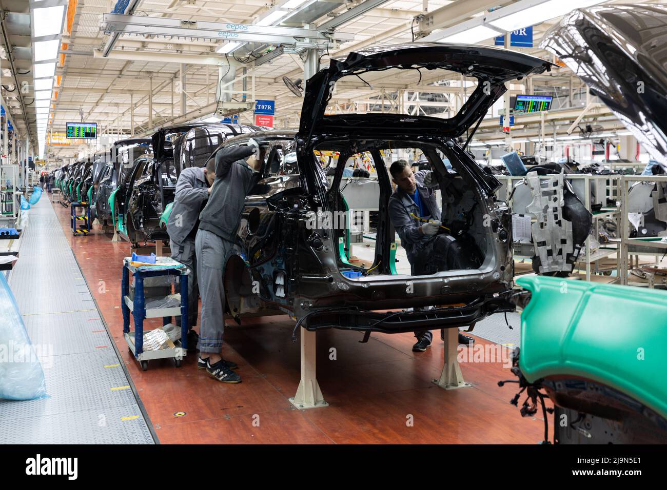 Car bodies are on assembly line. Factory for production of cars. Modern ...