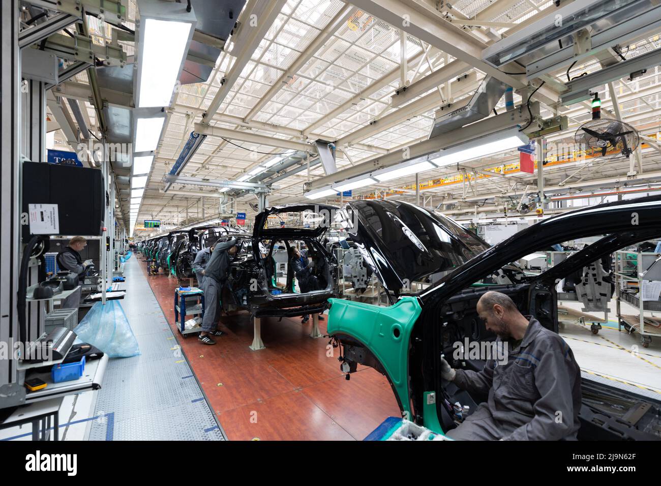 Car bodies are on assembly line. Factory for production of cars. Modern ...