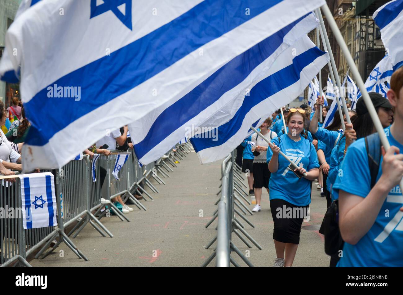 Participants are seen holding Israeli flags and marching during the ...