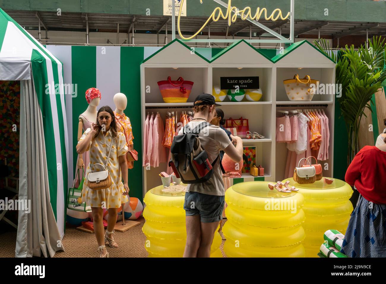 Visitors participate in the Kate Spade Cabana brand activation in the ...