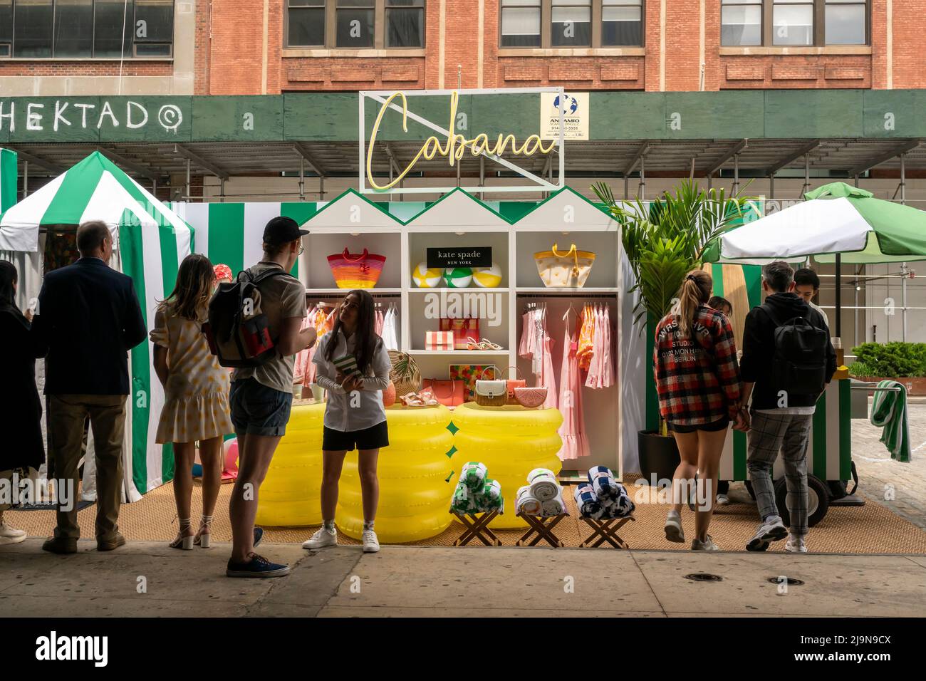 Visitors participate in the Kate Spade Cabana brand activation in the ...