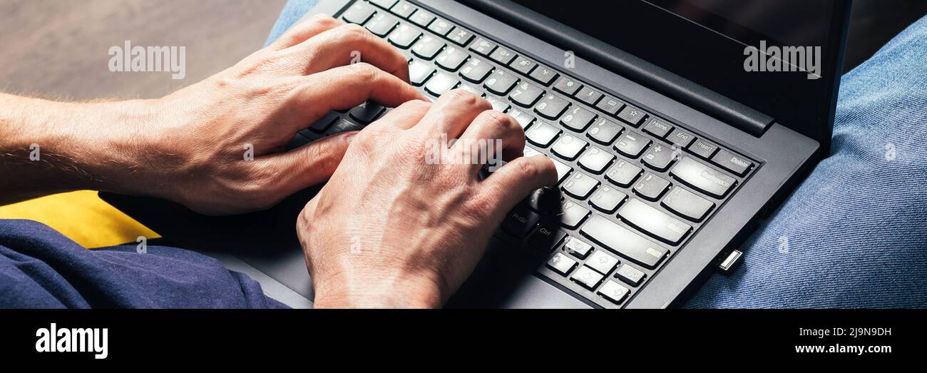 Male hands using laptop closeup, typing, programming banner. Panoramic ...