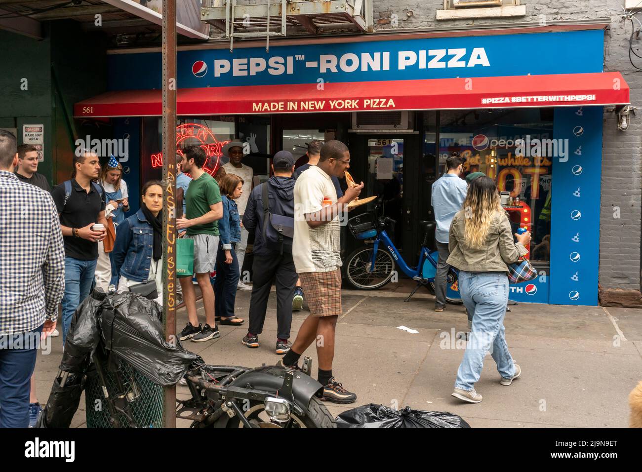 Passerby and the curious congregate in front of the Pepsi Cola Co.one ...