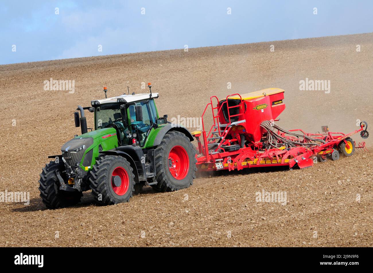 Tractor drilling seed on large arable field in Dorset, UK Stock Photo ...