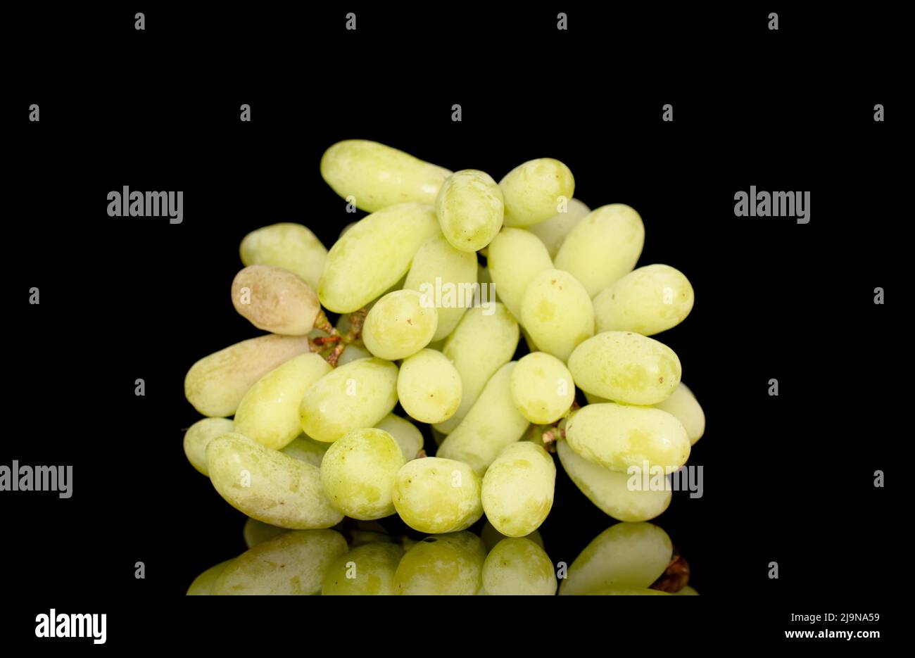 One bunch of white seedless grapes, close-up, isolated on a black ...