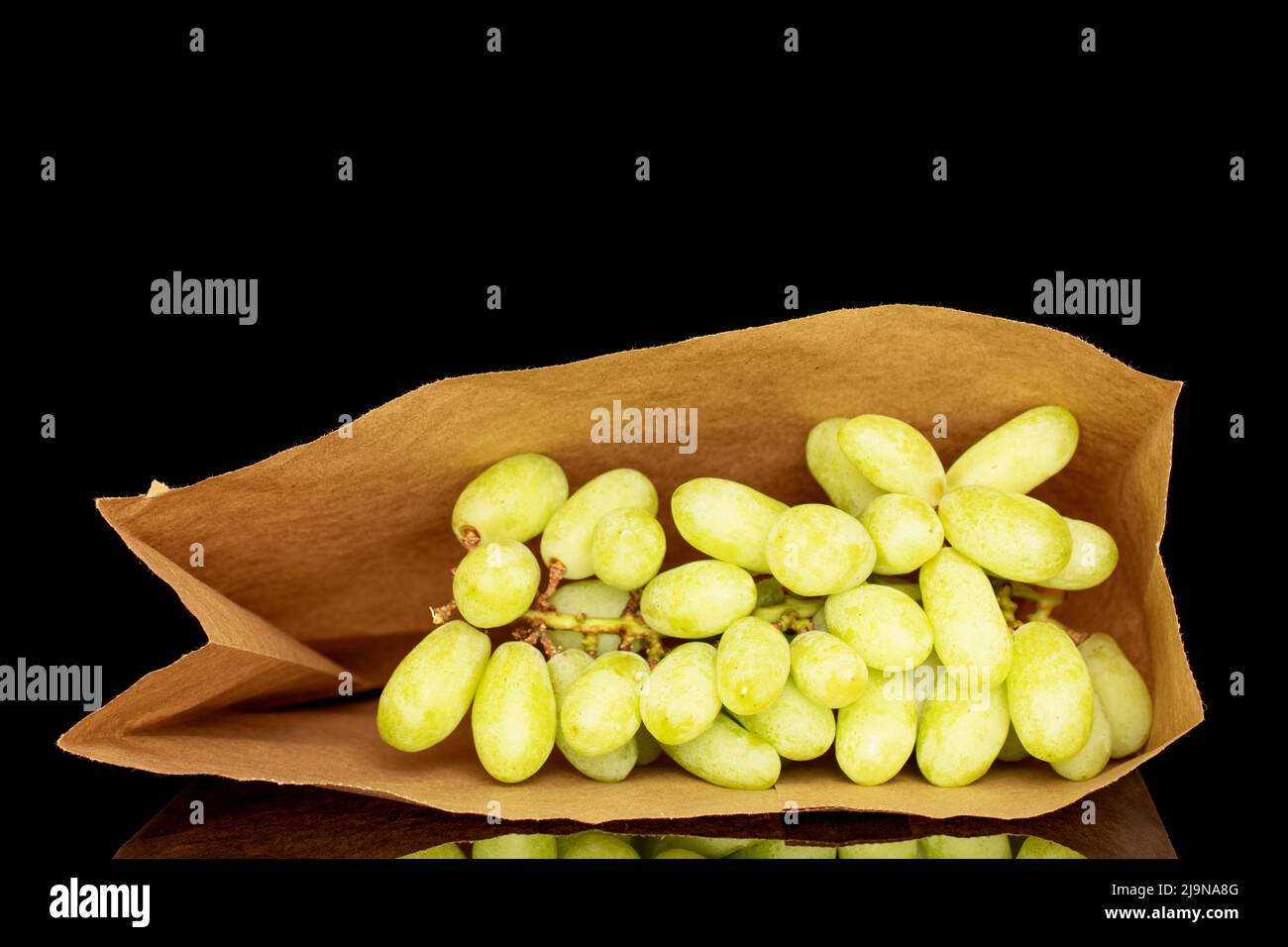 One bunch of white seedless grapes with a paper bag, close-up, isolated ...
