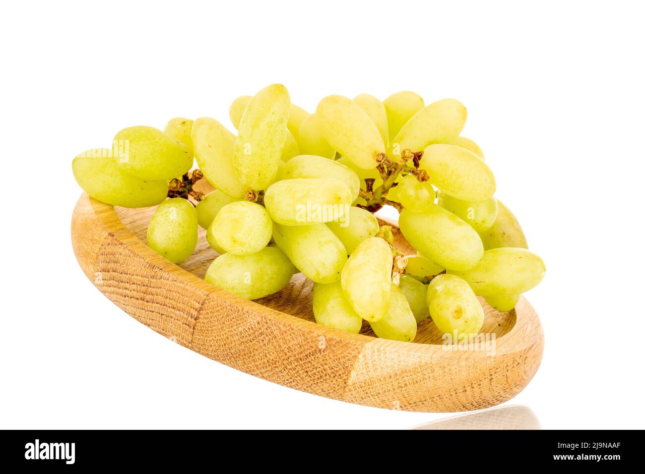 One bunch of white seedless grapes on a wooden tray, close-up, isolated ...