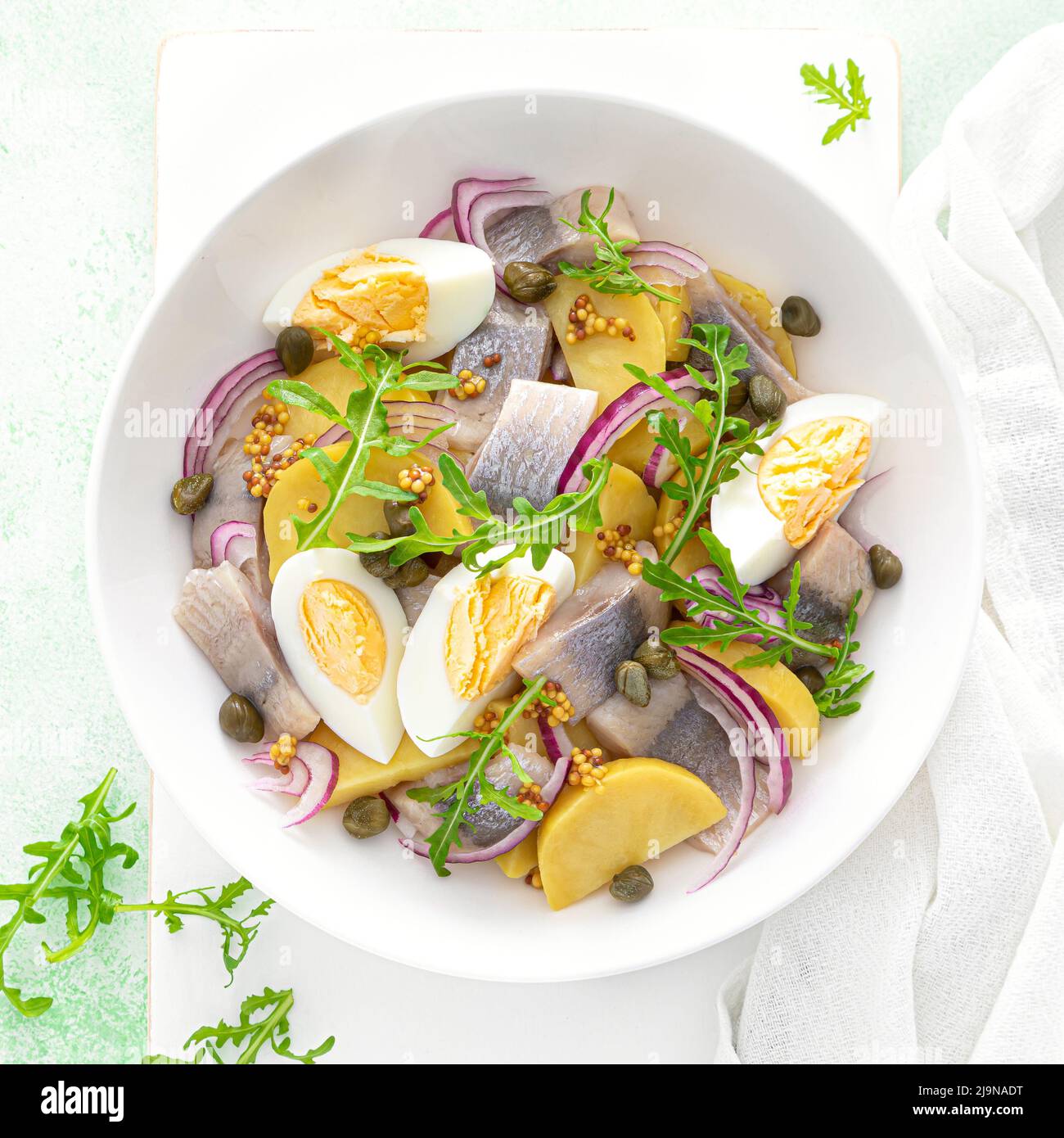 Herring and boiled potato salad with egg, capers and red onion. Top ...