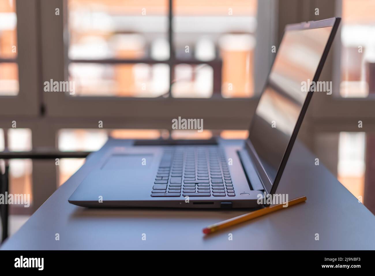 Laptop in a house with large windows prepared for teleworking Stock ...
