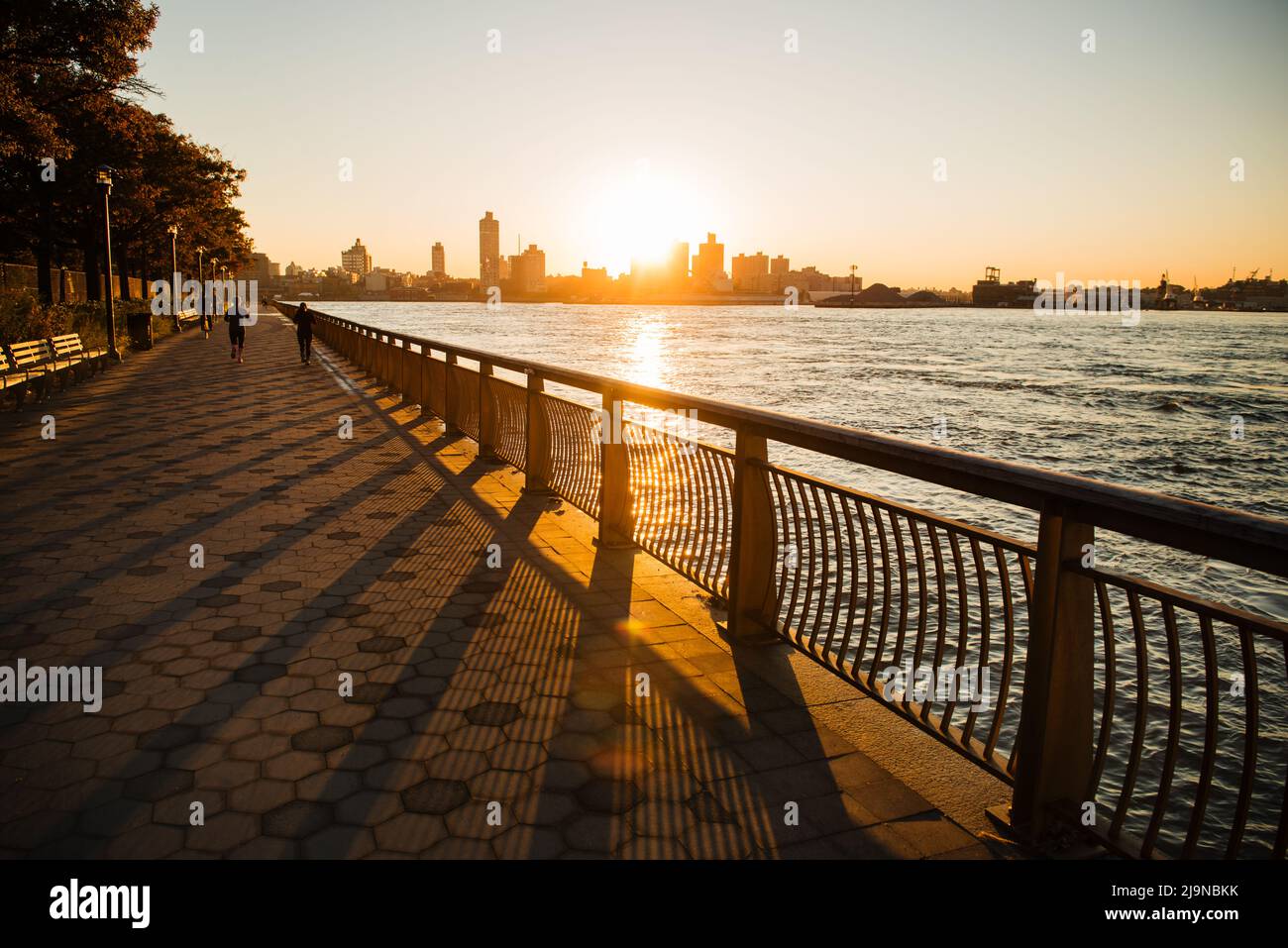 Walking path along the East River in Lower East Side Manhattan at ...
