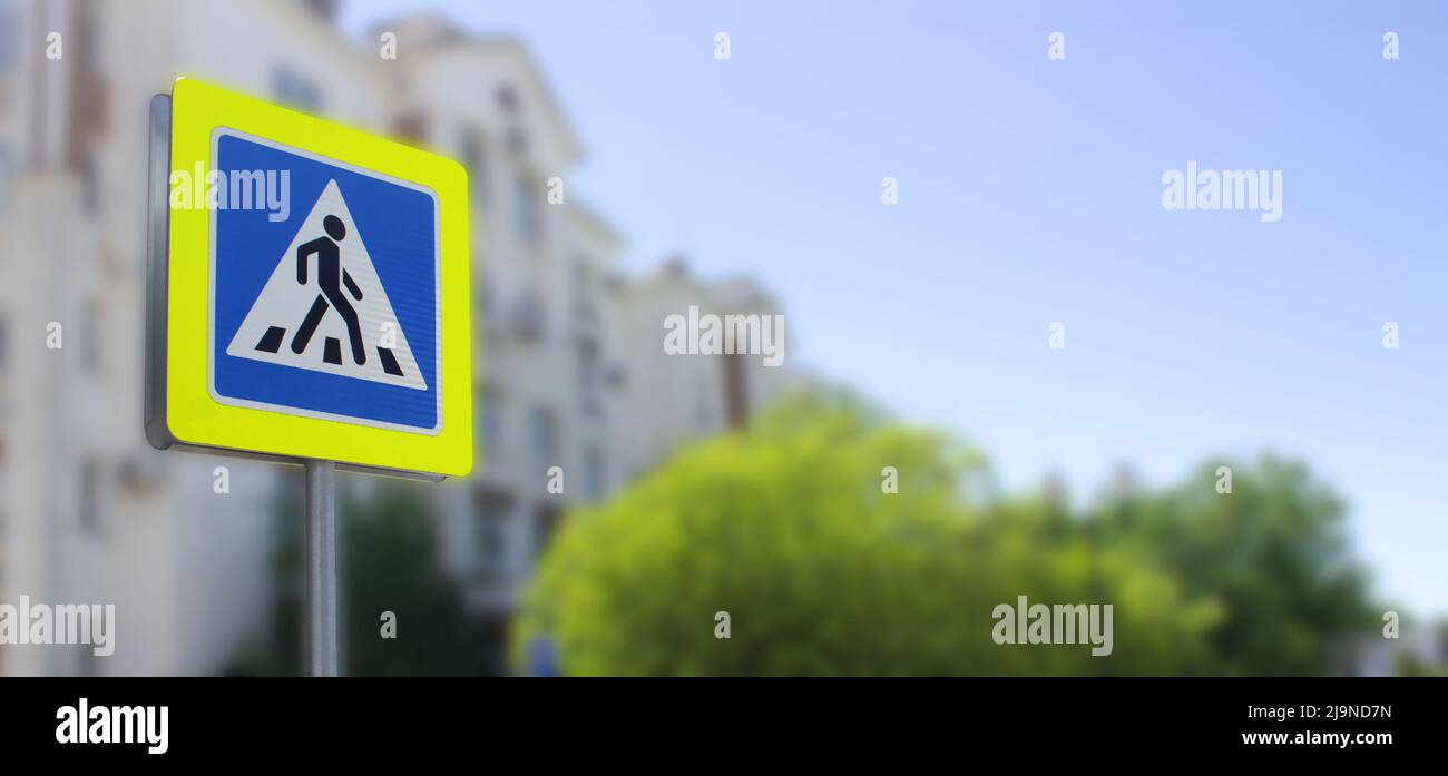 square road sign crosswalk close up on blurred background. A pedestrian ...