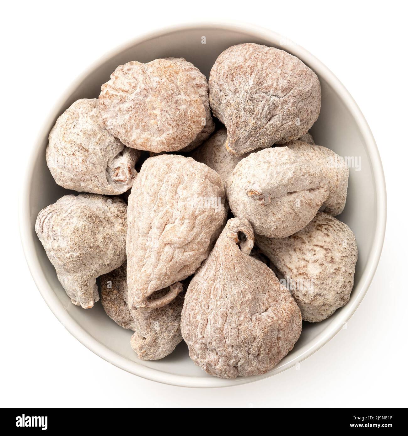 Dusted dried baby figs in a white ceramic bowl isolated on white. Top ...