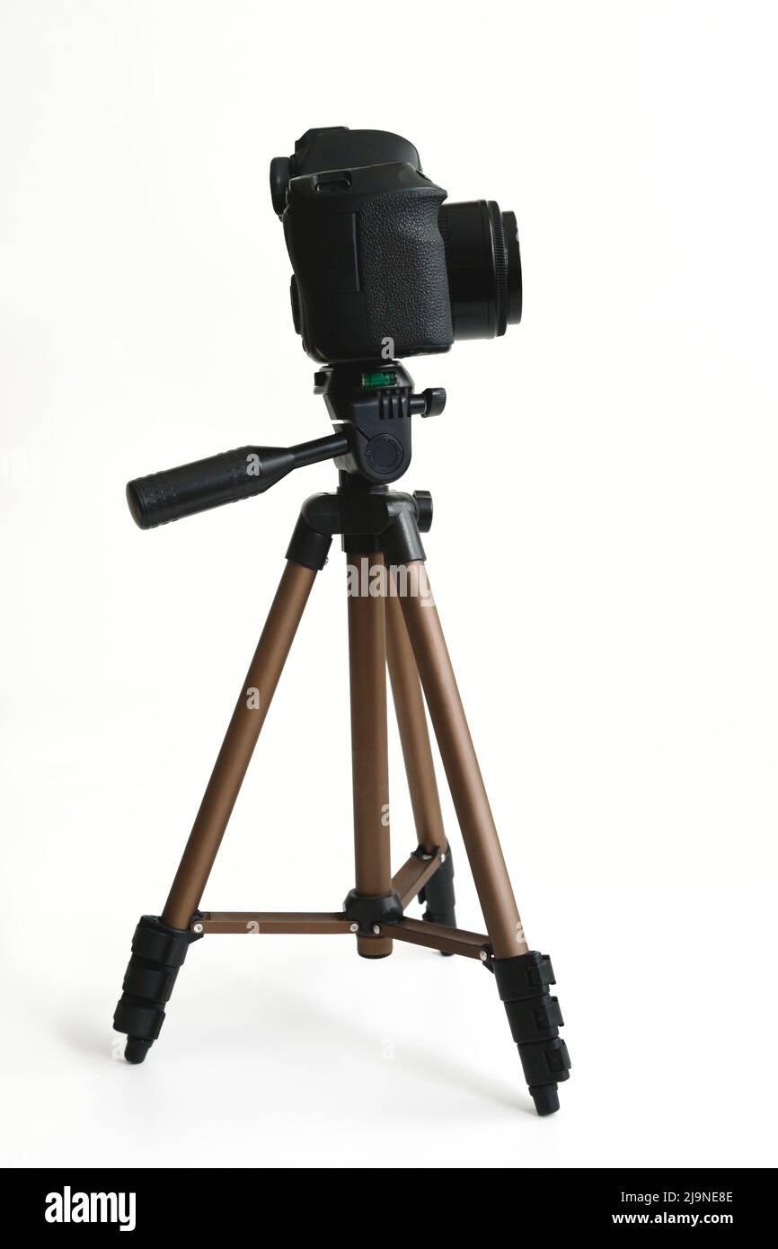 Modern compact tripod with camera on white with shadow. Side view Stock ...
