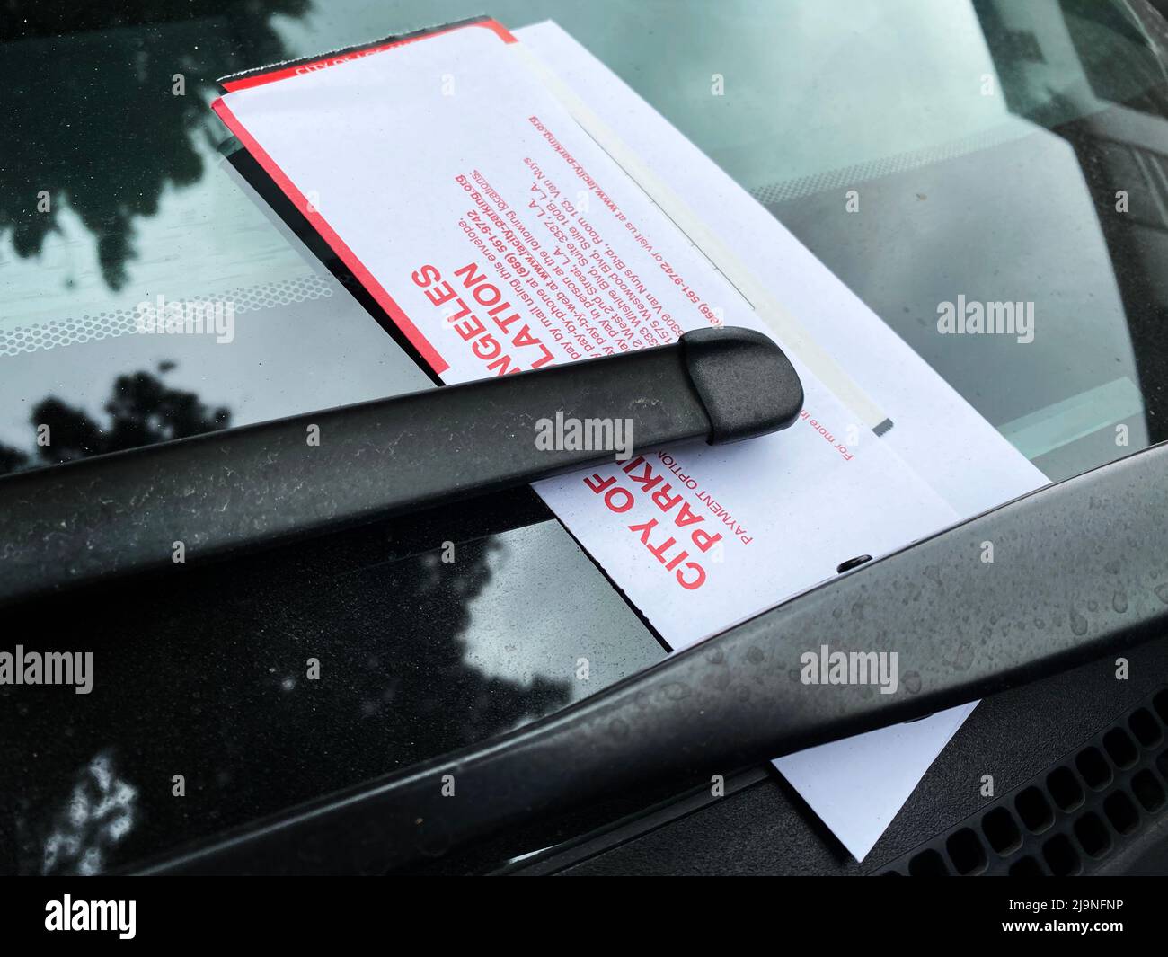 A parking ticket on a windshield Stock Photo - Alamy