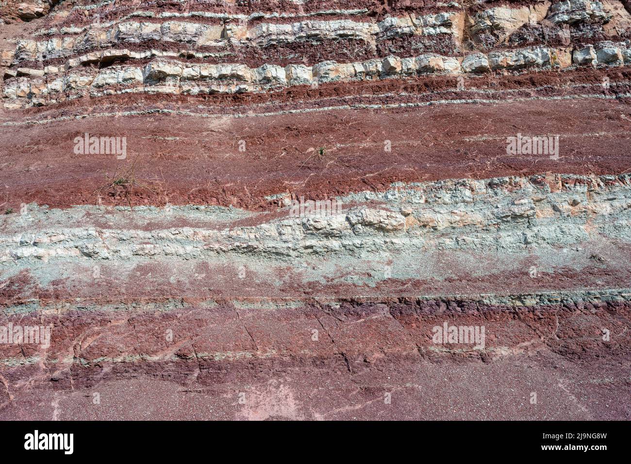 Colored layers of clay and stone in the soil section, various rock ...