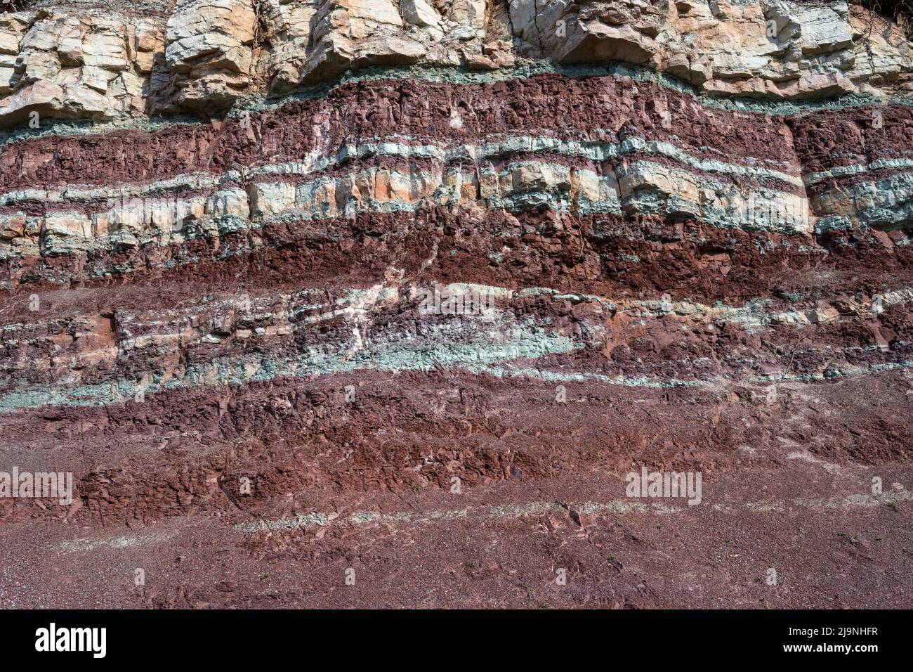 Colored layers of clay and stone in the soil section, various rock ...