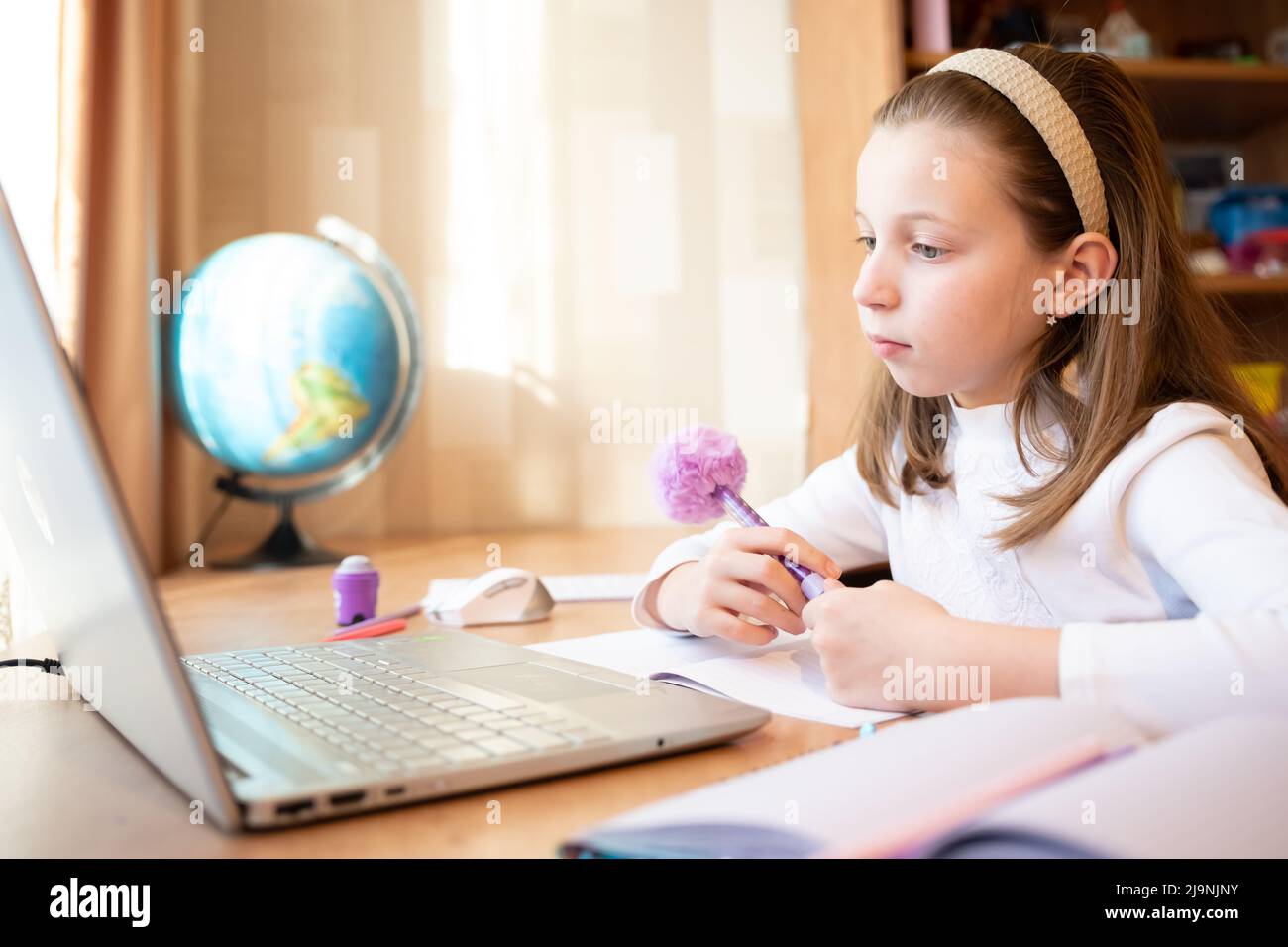 Online remote learning. High school kids with computer having video conference chat with teacher ...