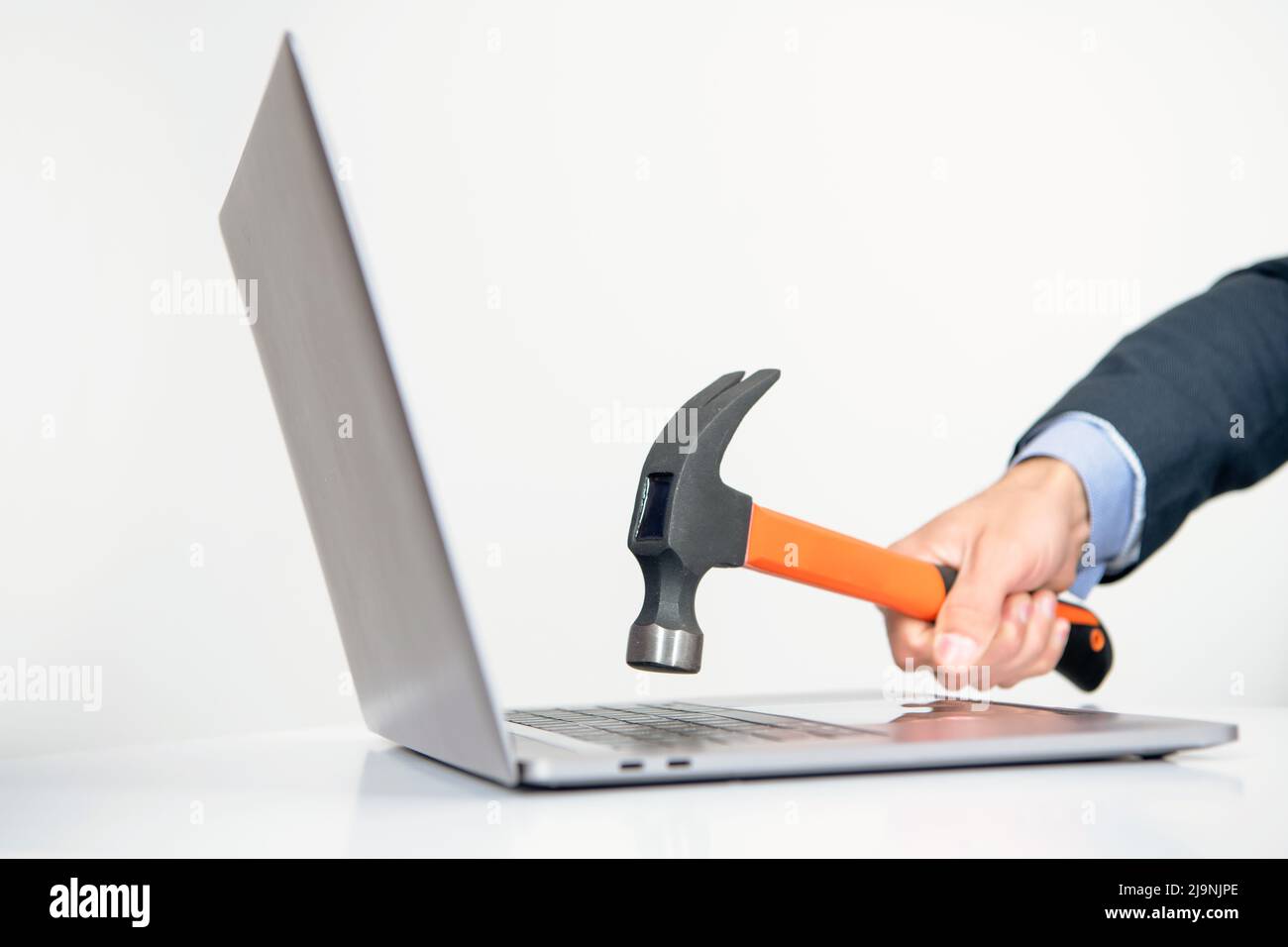 hammer in hand hitting the computer, closeup Stock Photo - Alamy