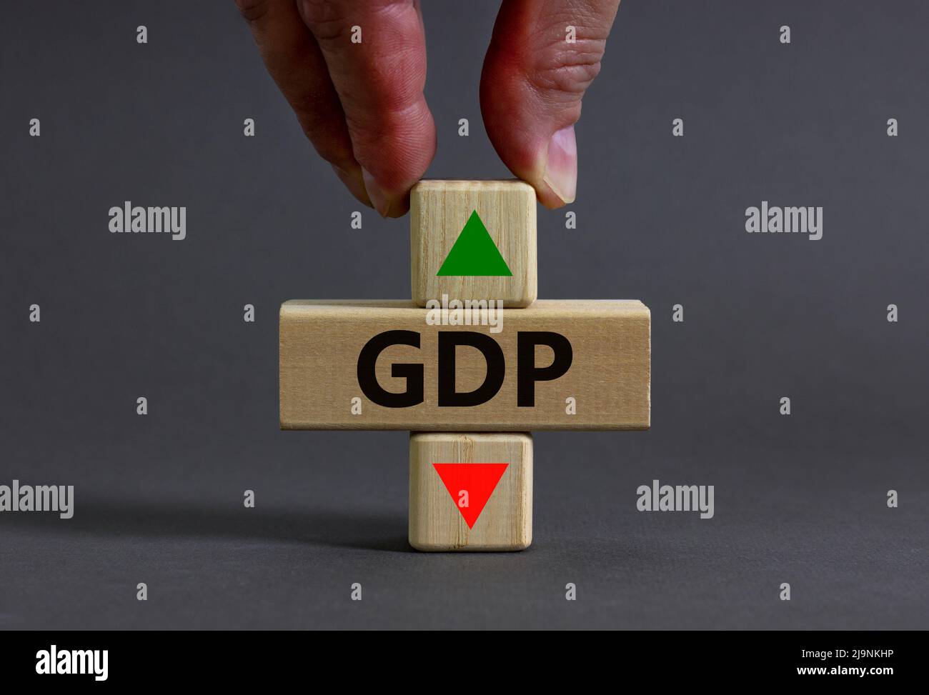 GDP gross domestic product symbol. Businessman holds a cube with up ...