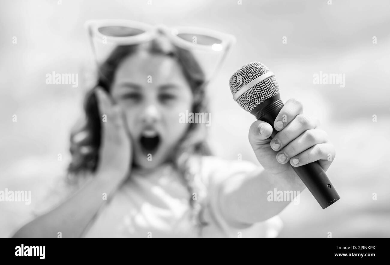 kid sing with mic. selective focus. cheerful event manager. child have ...