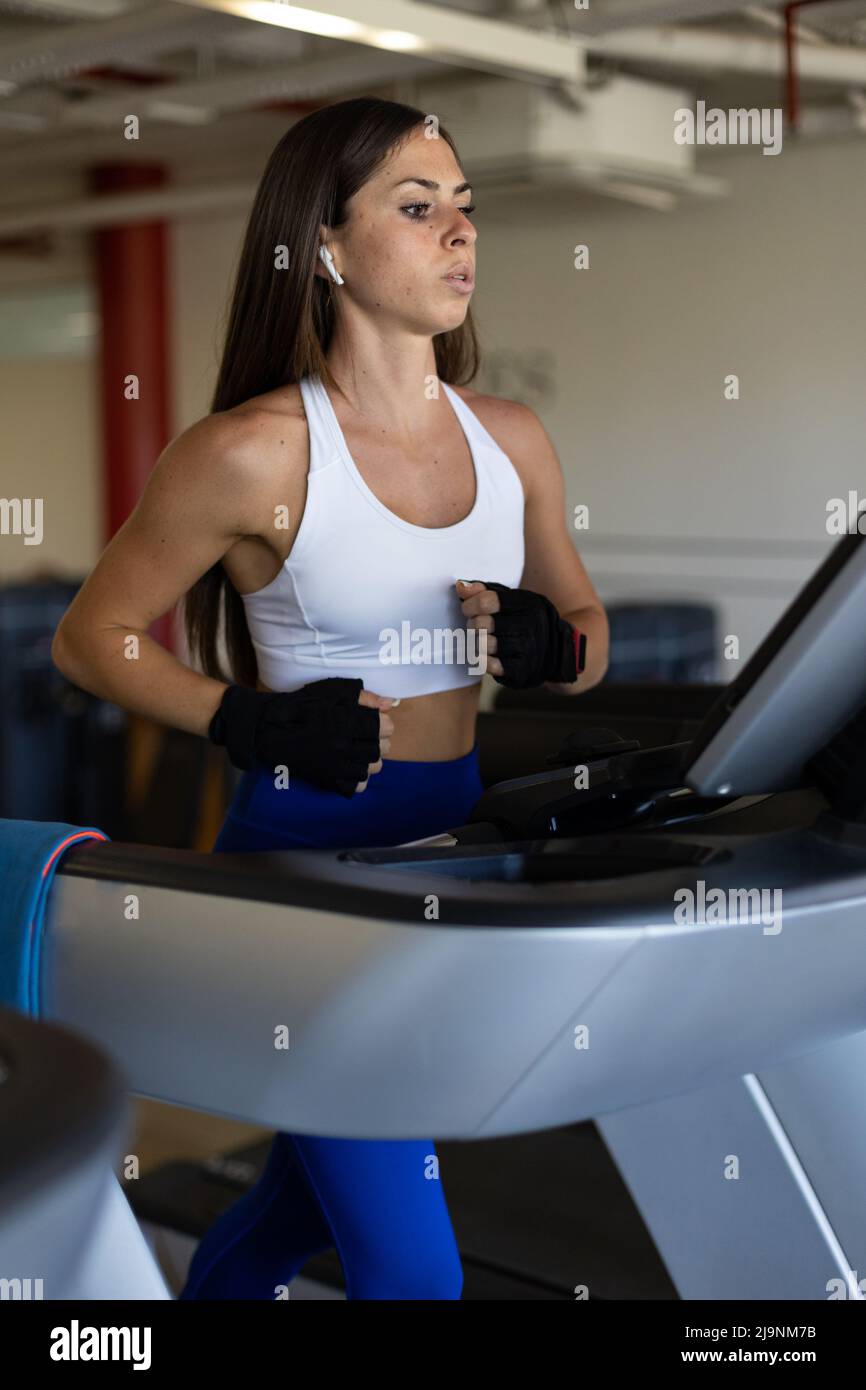 woman training on a treadmill inside a gym Stock Photo - Alamy