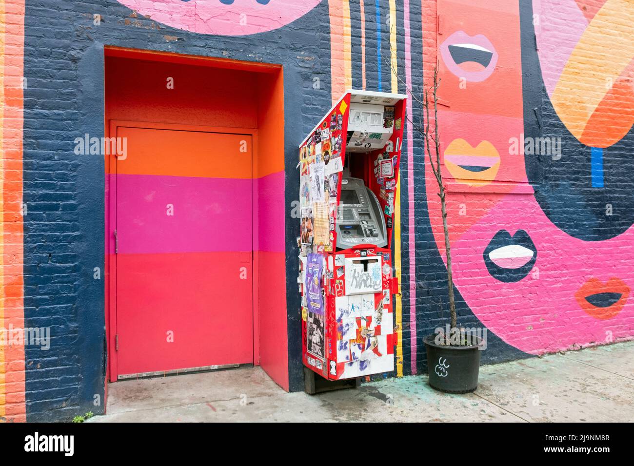 A collage of stickers, tags, notices & graffiti on an outdoor ATM ...