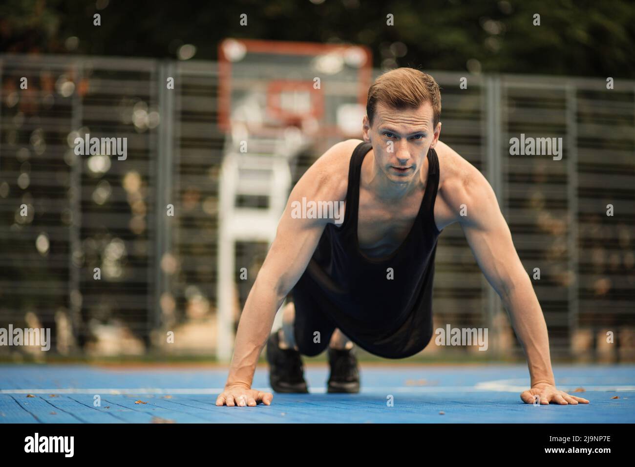 Young man has fitness workout. Male athlete does abs exercise, sport ...