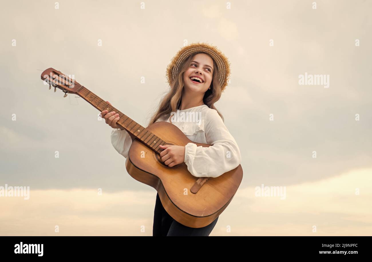 stylish child girl playing guitar outdoor, vocal Stock Photo - Alamy