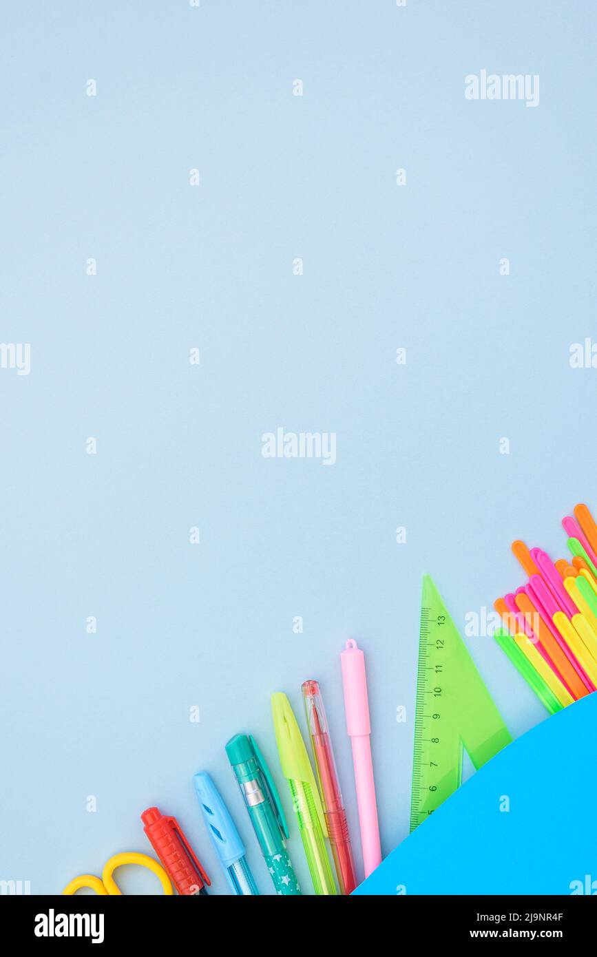 Vertical composition with school stationery border frame on blue ...