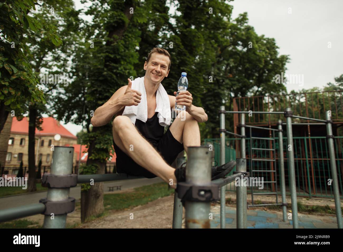 Little break. Young athletic guy with muscular body, sportsman and ...