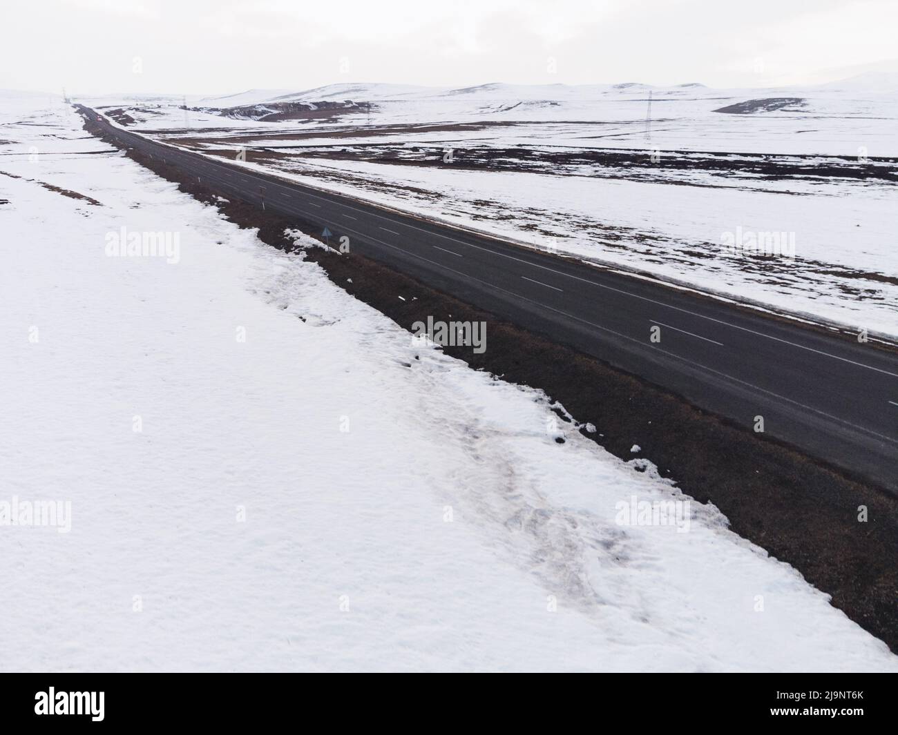 Aerial diagonal view of a road with one lane and snow in winter Stock ...