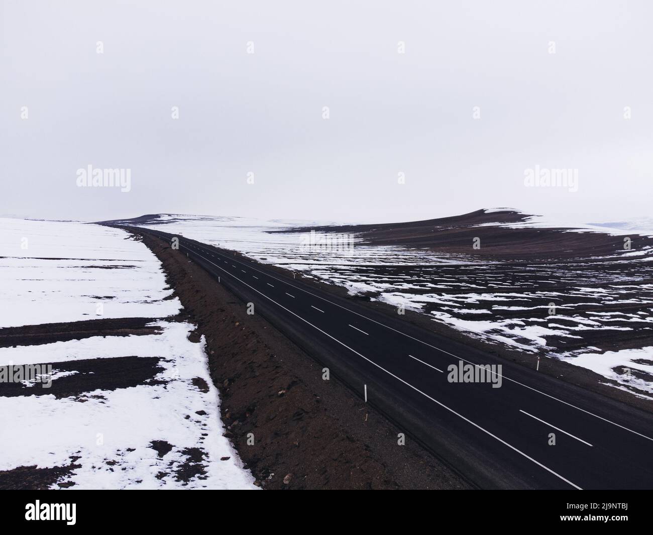 Aerial diagonal view of a road with one lane and snow in winter Stock ...