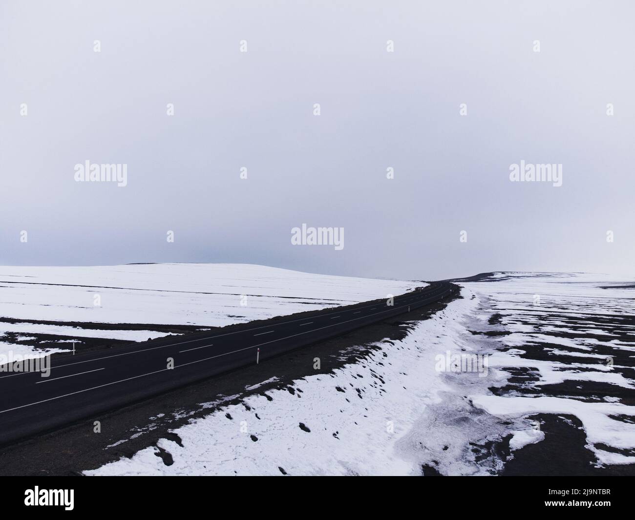 Aerial diagonal view of a road with one lane and snow in winter Stock ...