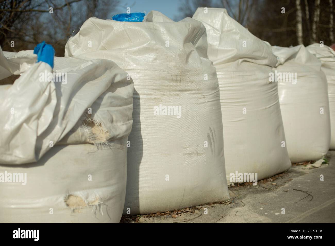 White sandbags. Large bags of material for construction. Construction ...