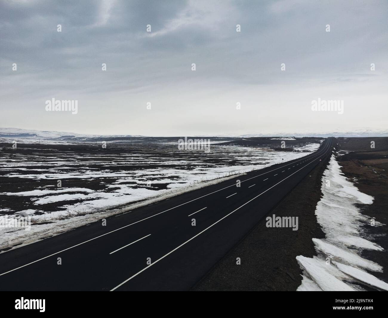 Aerial diagonal view of a road with one lane and snow in winter Stock ...