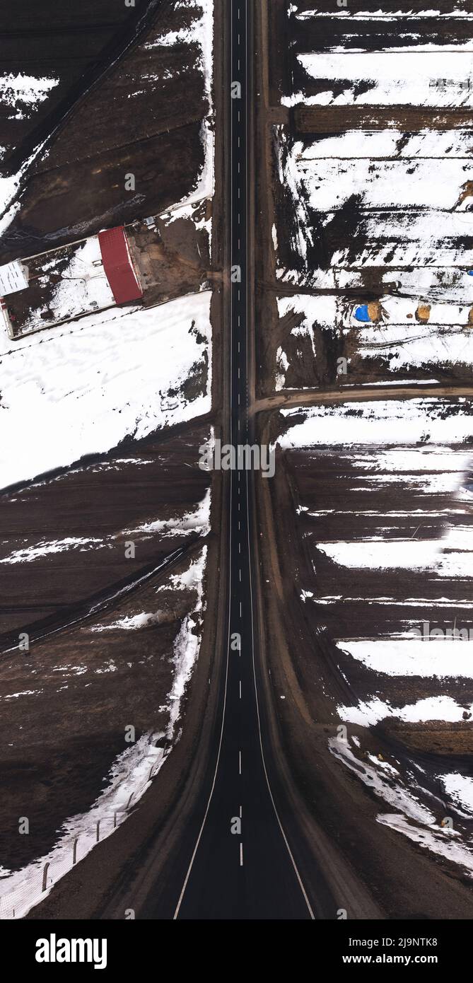 Aerial diagonal view of a road with one lane and snow in winter Stock ...