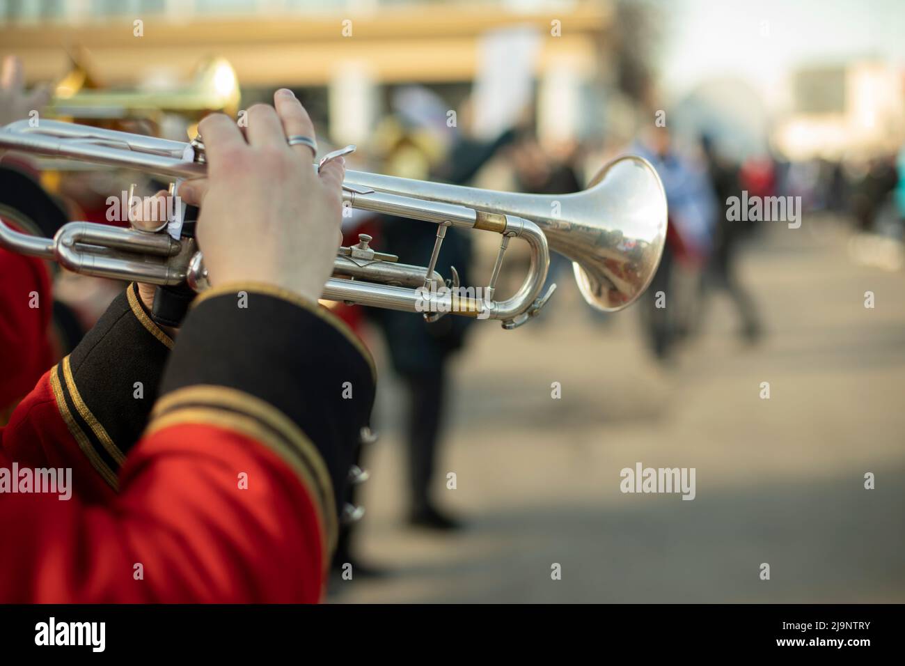 Orchestra with wind instruments. Trumpeters in ceremonial uniforms. Red ...