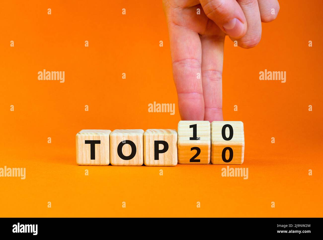 From Top 20 to 10 symbol. Businessman turns wooden cubes and changes ...