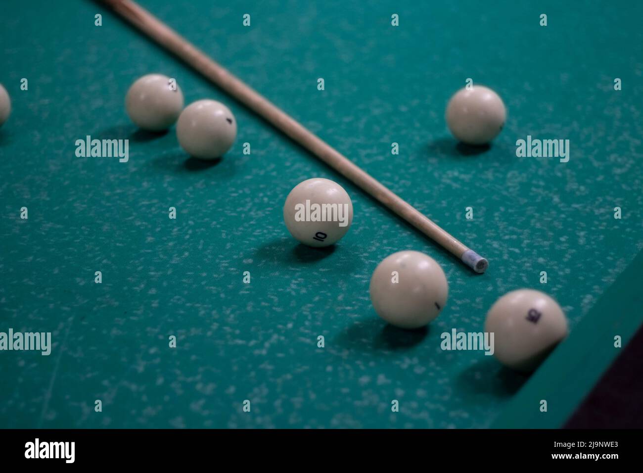 Billiard balls are white. Green billiard table. Playing in bar. Sports ...