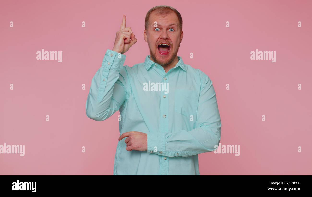 Inspired adult man pointing finger up, showing Eureka gesture, solution ...