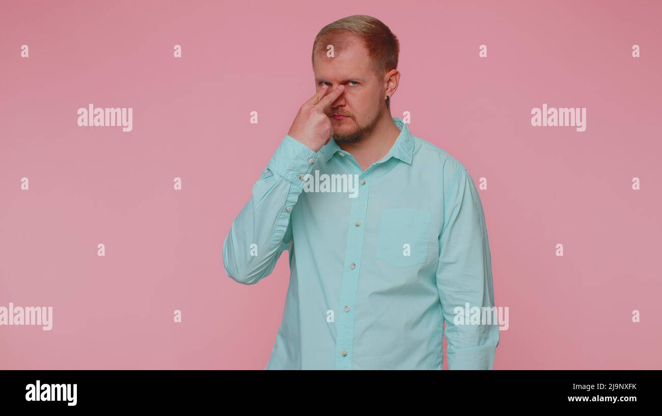 Serious man pointing at his eyes, show I am watching you gesture ...