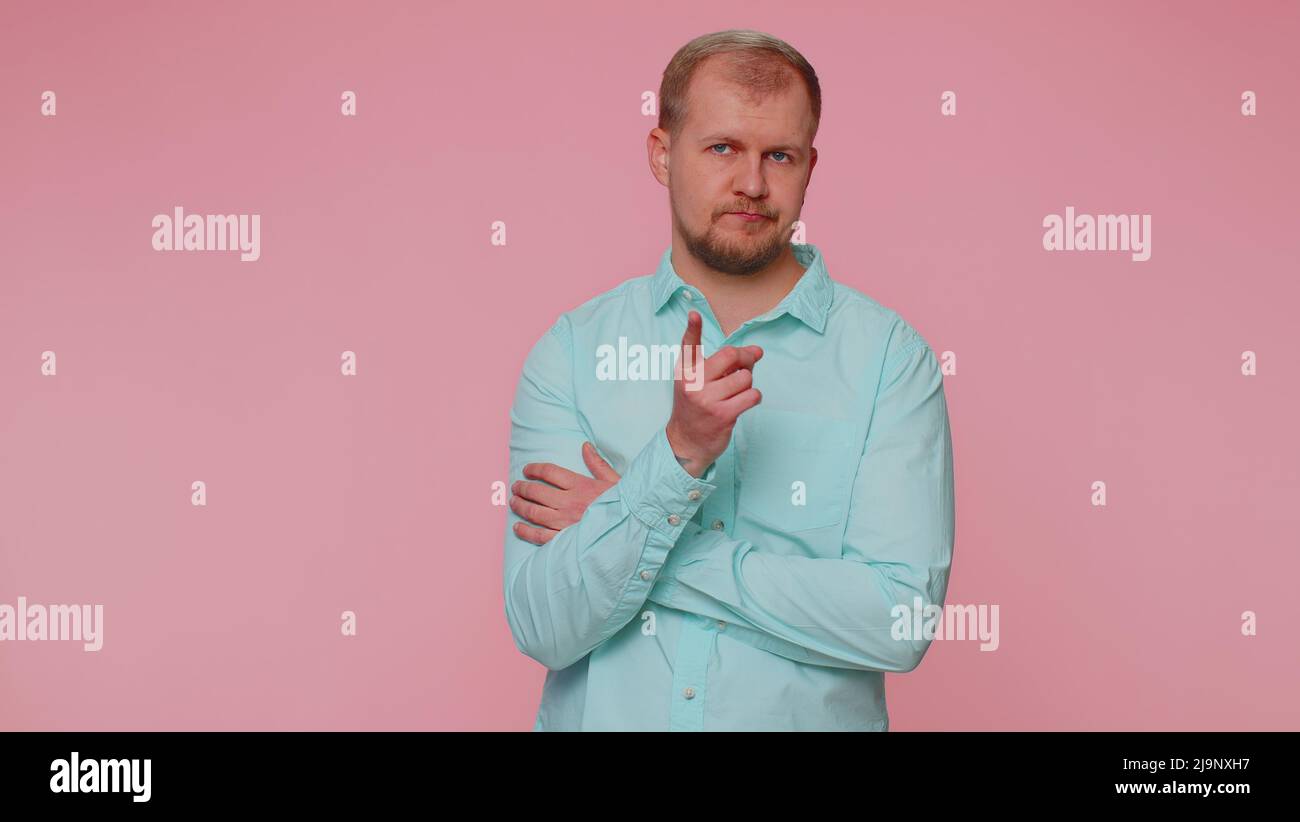 Displeased man shakes finger, saying no, be careful, scolding, giving ...