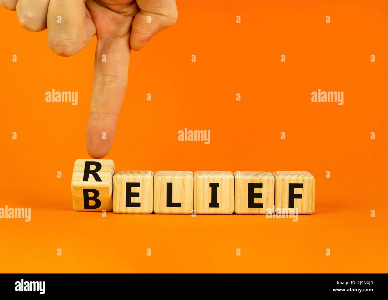 Belief or relief symbol. Businessman turns wooden cubes, changes ...