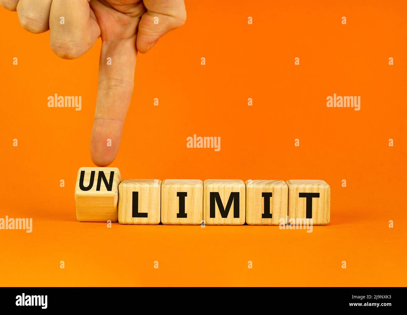 Limit or unlimit symbol. Businessman turns wooden cubes and changes the ...