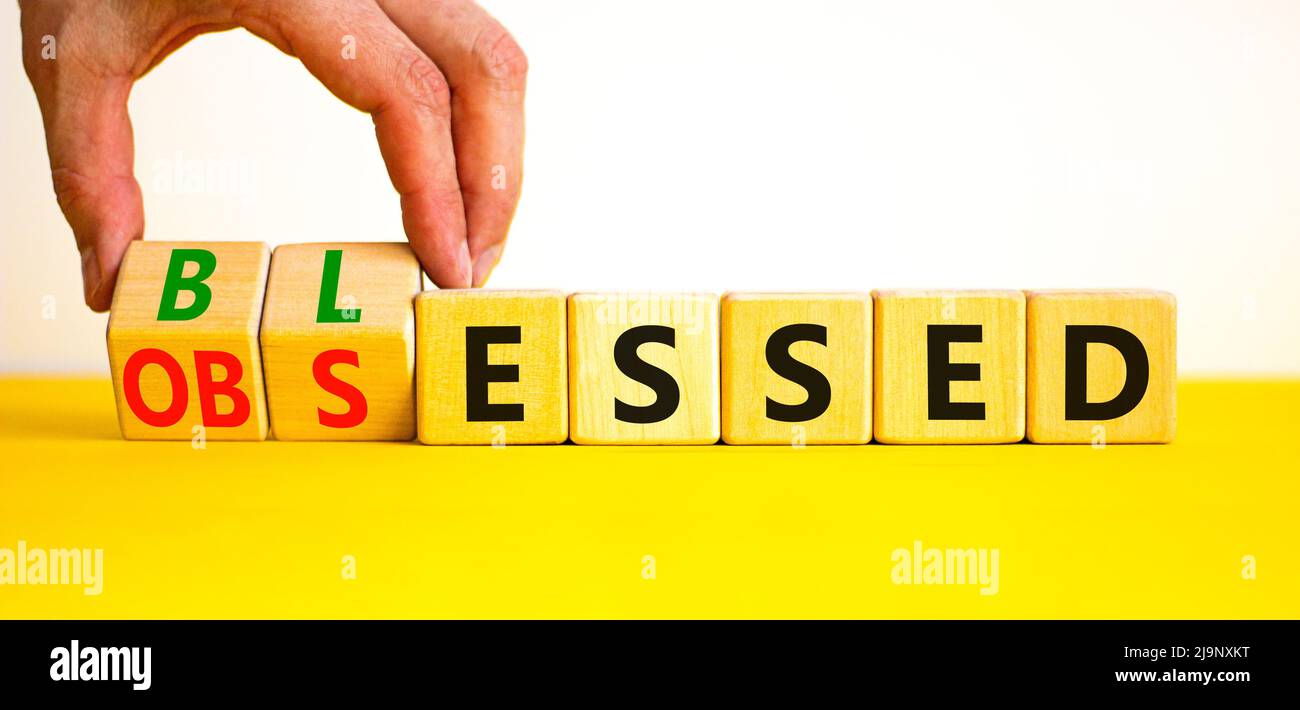 Blessed or obsessed symbol. Businessman turns wooden cubes and changes ...