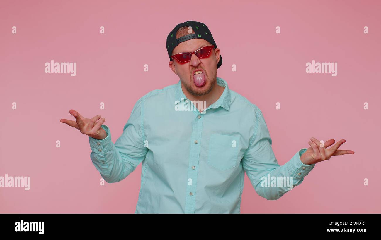 Funny joyful man making playful silly facial expressions, grimacing ...