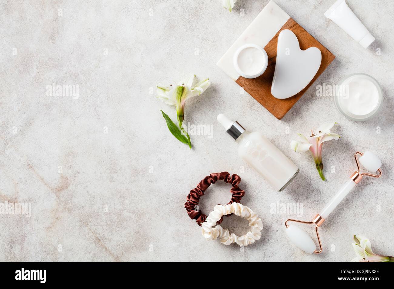 Face skin care concept. Flat lay face roller, gua sha, serum ...