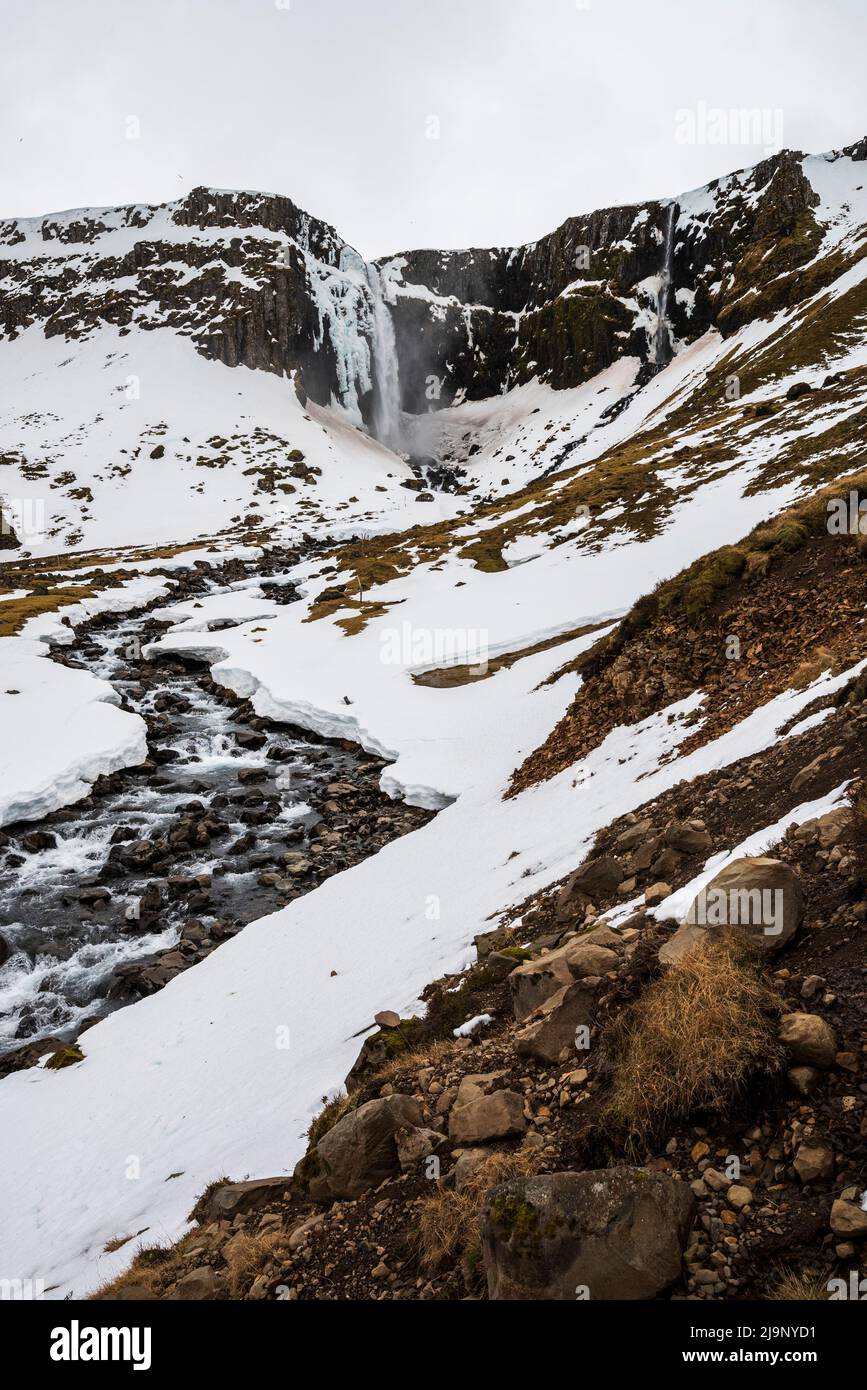 The beautiful Grundarfoss waterfall and the river Grundará in a snow ...